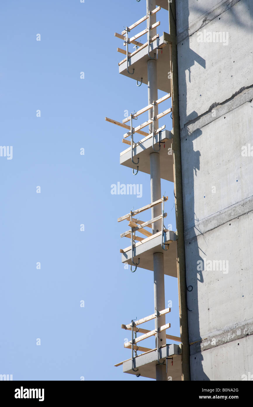 Temporary wooden handrails at block of flats balconies at construction ...