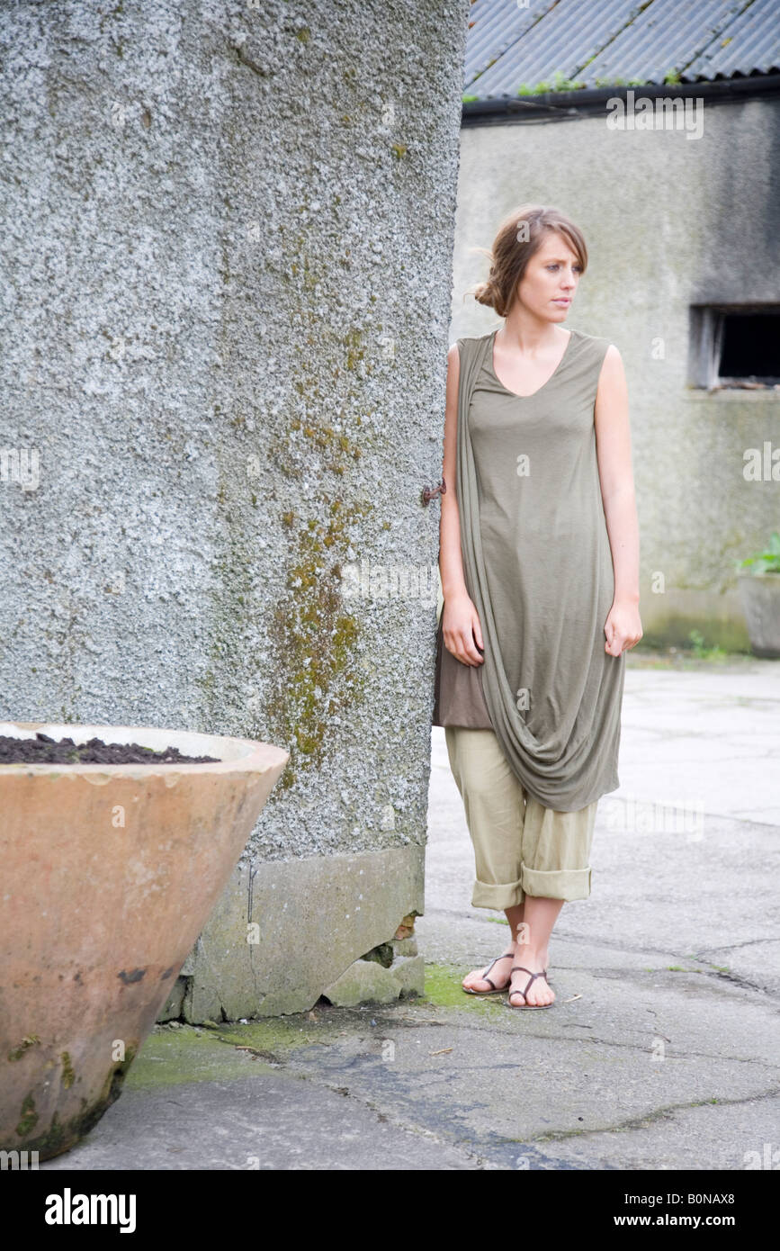 Girl posing by a wall Stock Photo - Alamy