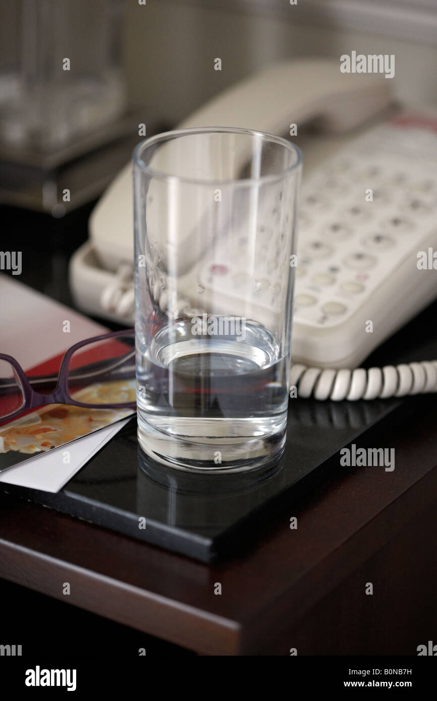 Glass of water at bedside table Stock Photo - Alamy