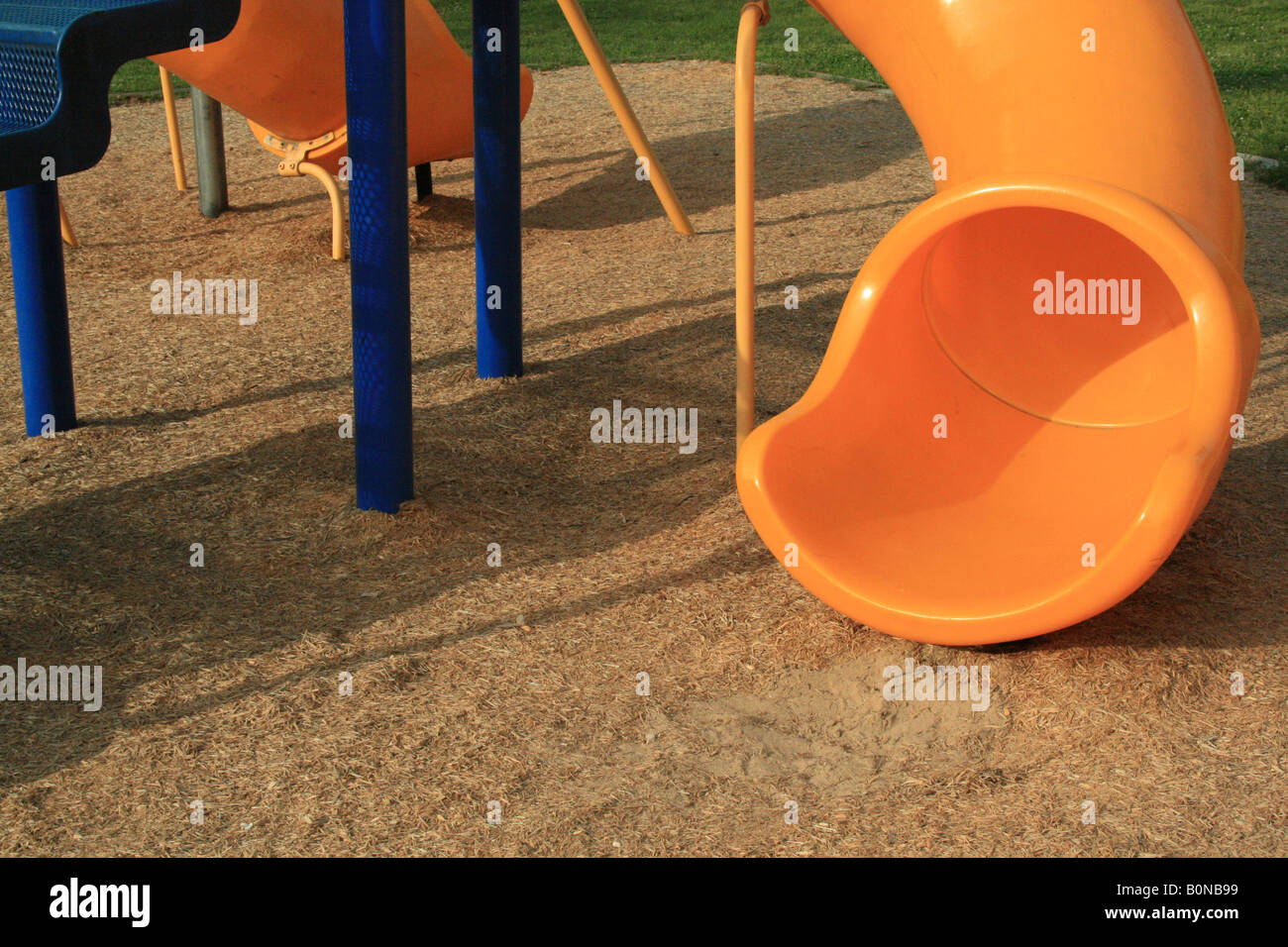 The mouth of a yellow tunnel slide in a small park Stock Photo - Alamy