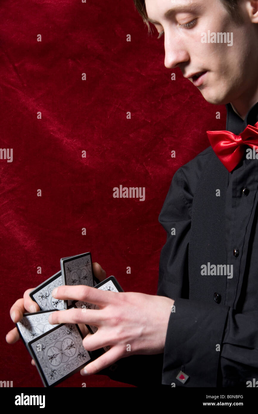 young magician doing a card trick Stock Photo - Alamy