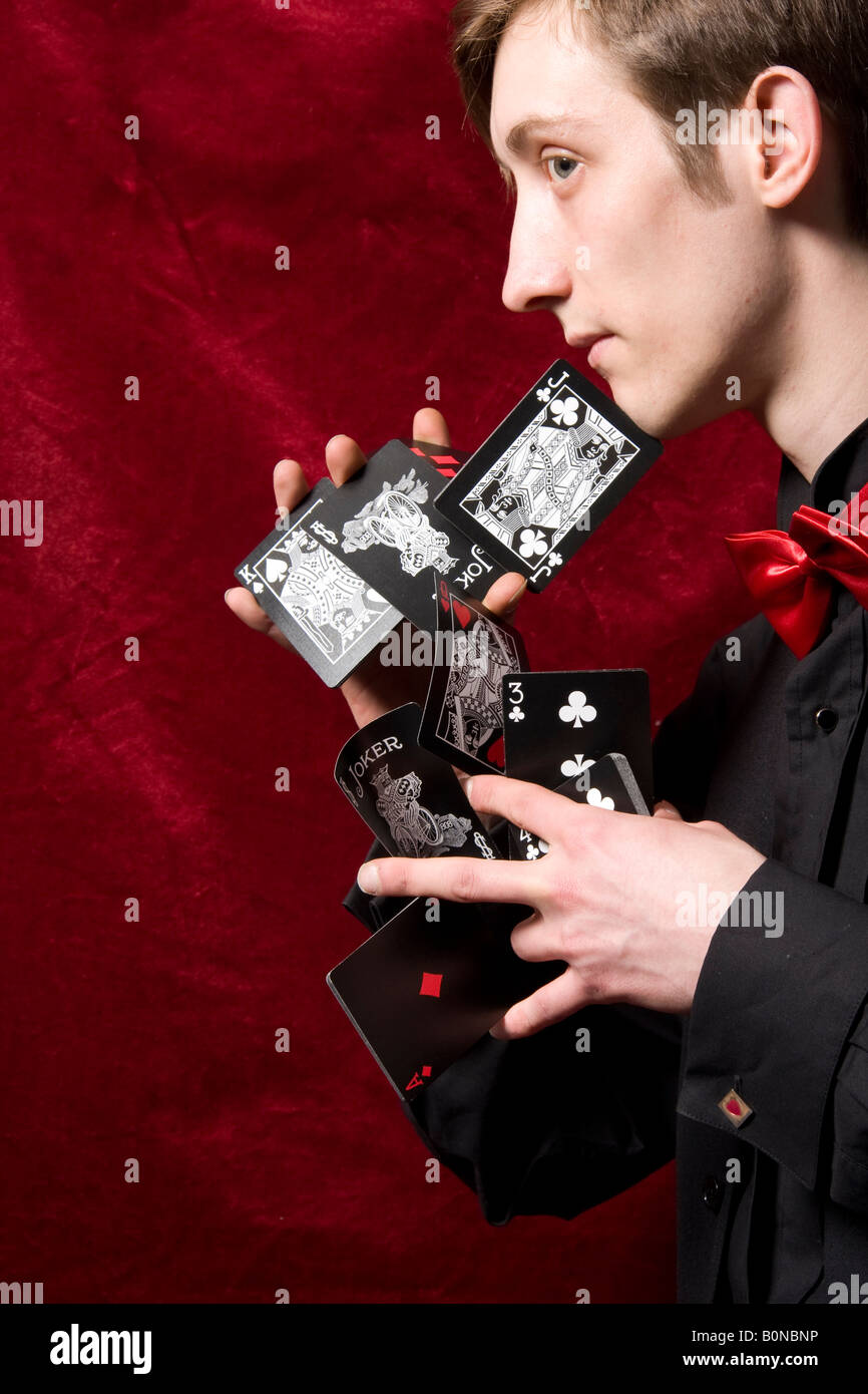young magician doing a card trick Stock Photo - Alamy