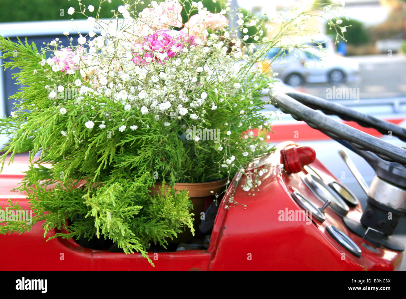 Romantic red car with flowers in the street Stock Photo - Alamy