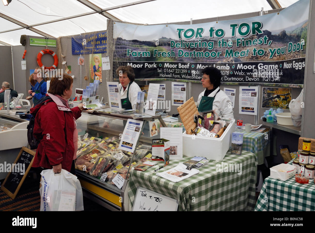 Woman buying meat from a food stall at the Devon County Show, Exeter ...