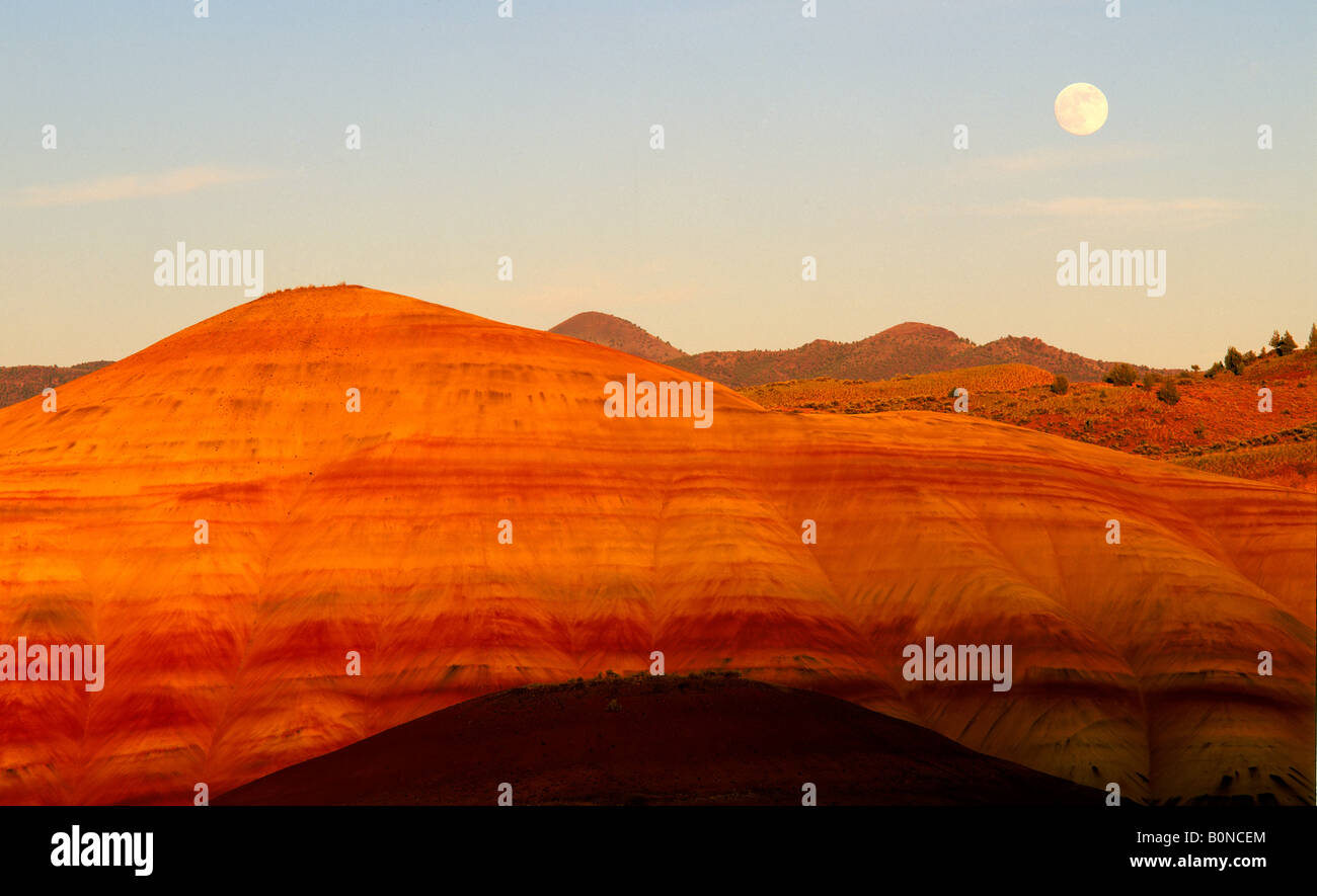 A full moon rises over the eroded volcanic mud of the Painted Hills ...