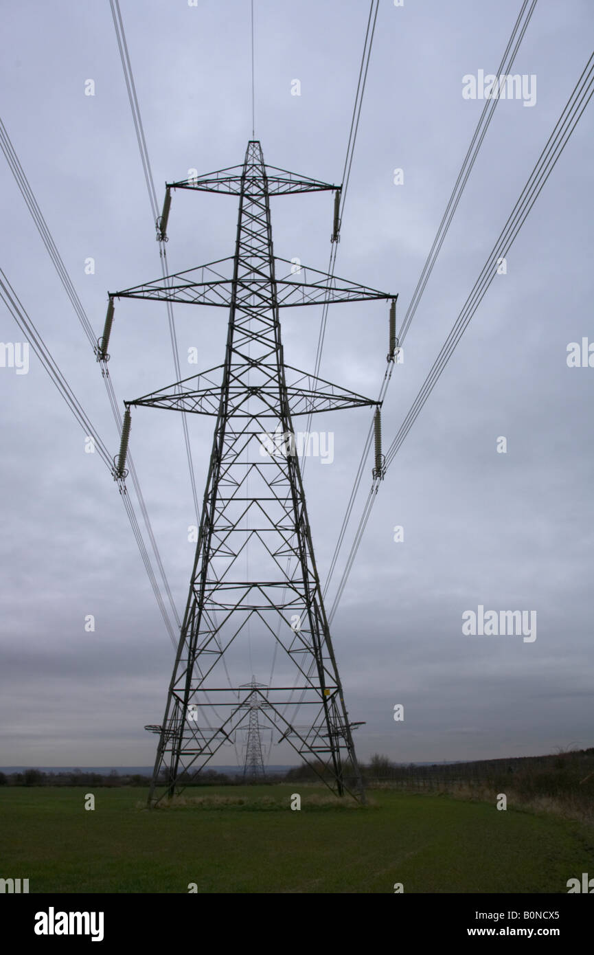 Electricity pylons stretching across the gloomy English countryside ...