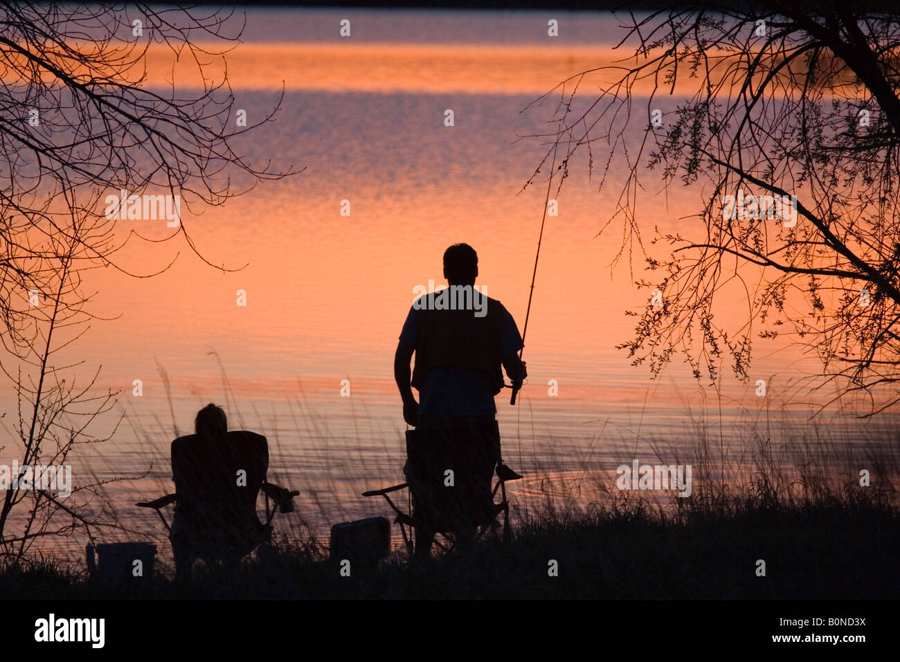 Nightfall sunset mountains lake family couple fishing hi-res stock ...