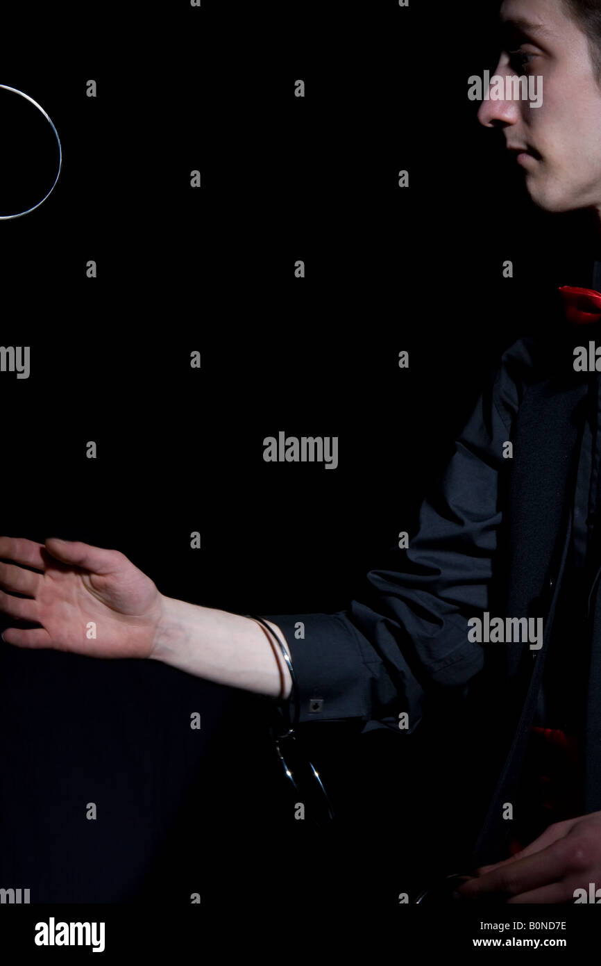 young magician performing trick with a hoop Stock Photo - Alamy