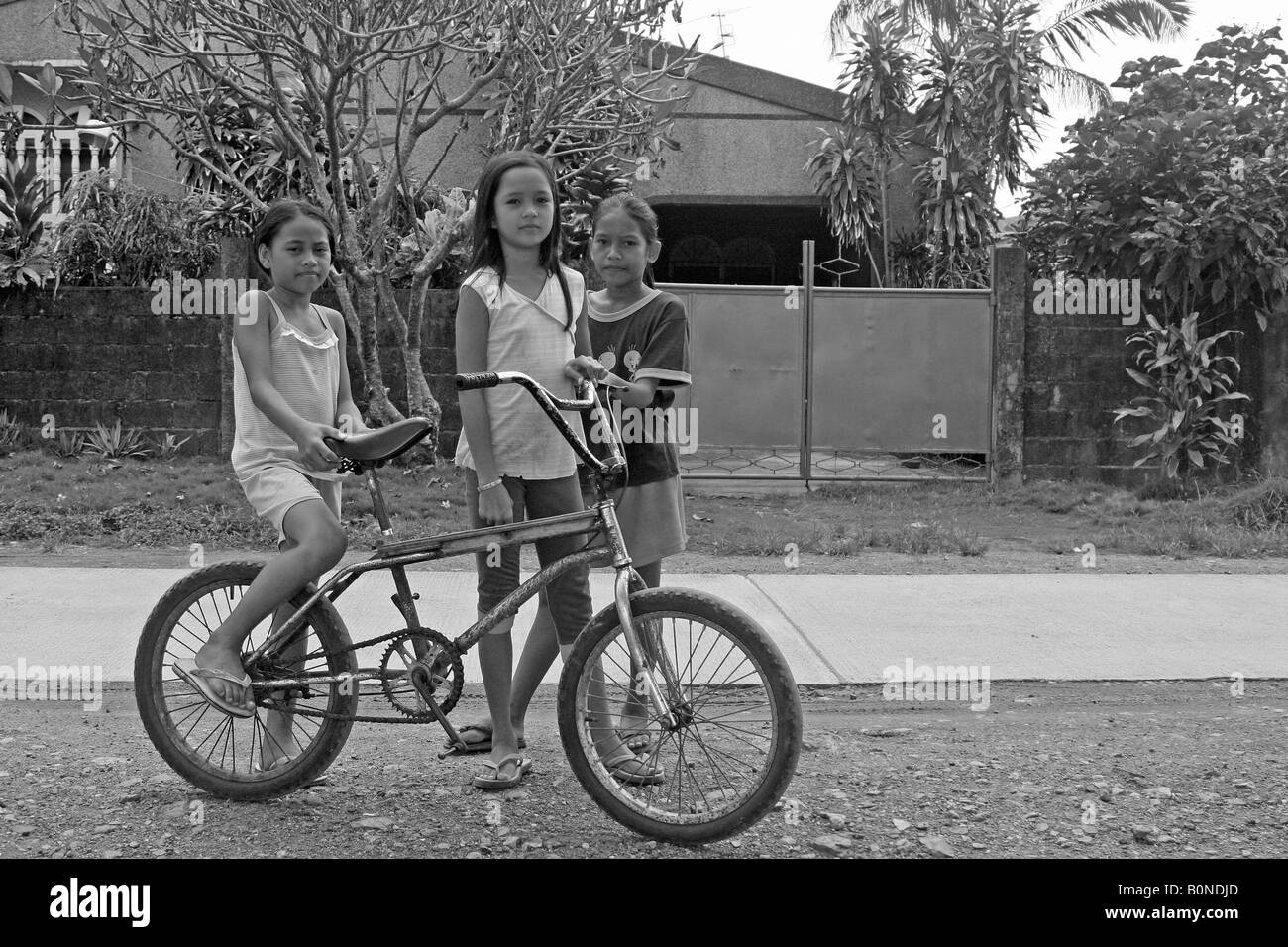 Filipino girls with bicycle Stock Photo - Alamy
