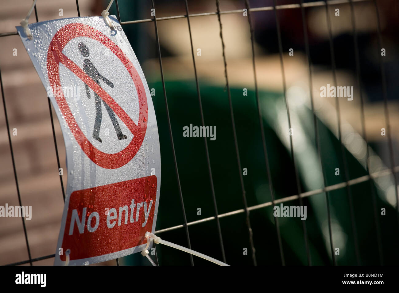 No entry sign on fence surrounding building site Sandbanks Dorset UK ...