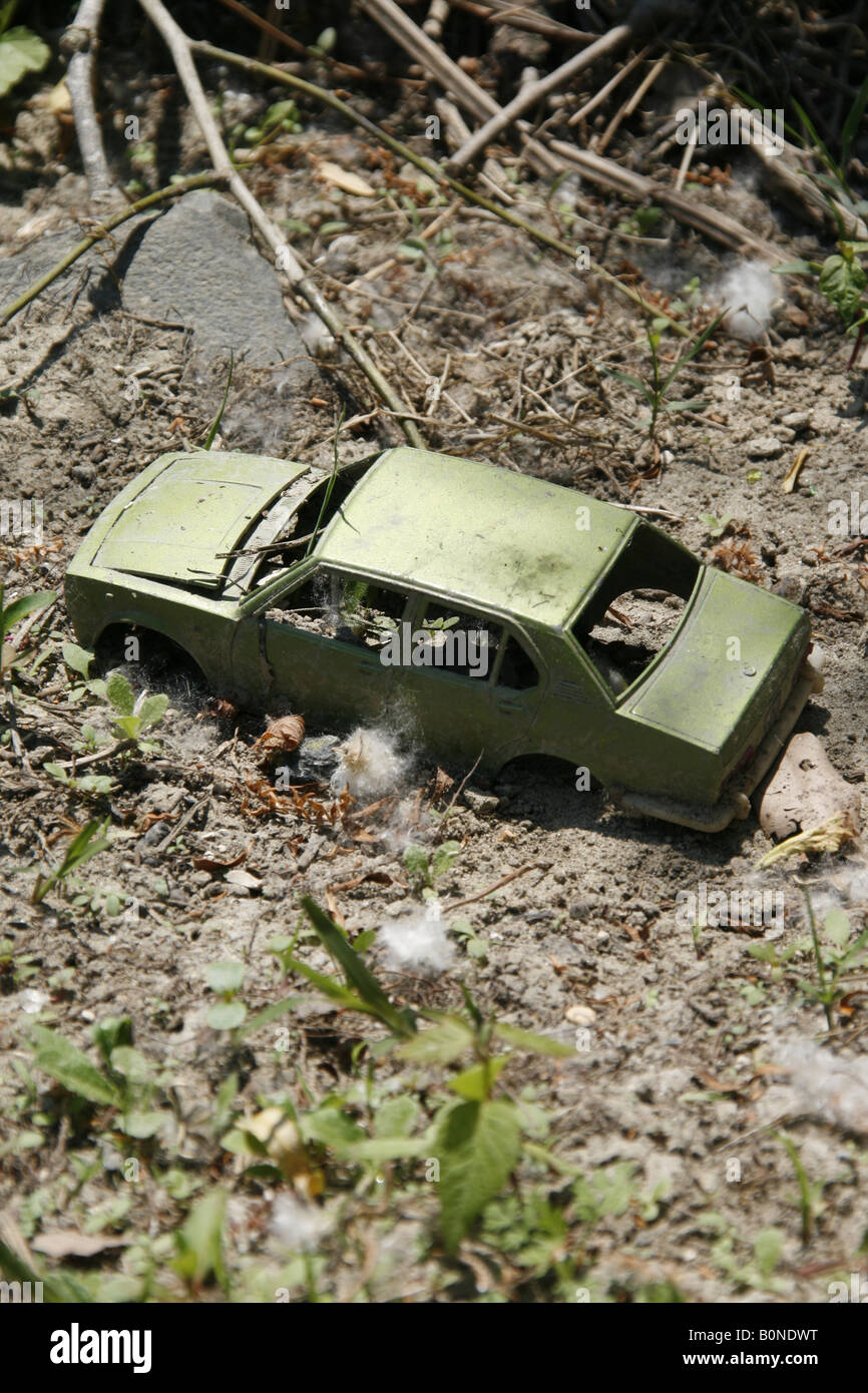 old damaged green toy car in field Stock Photo - Alamy