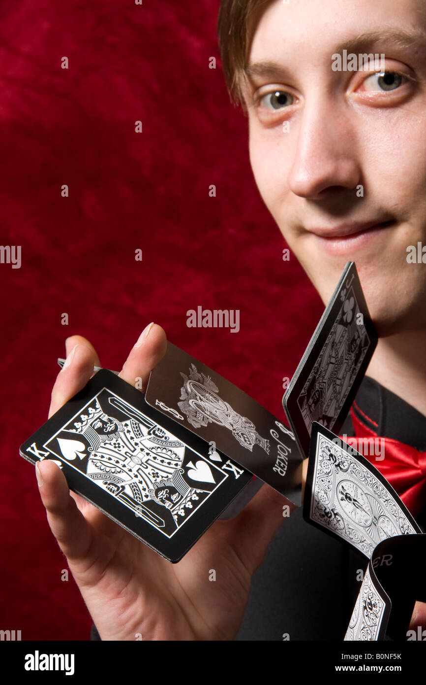 young magician doing a card trick Stock Photo - Alamy