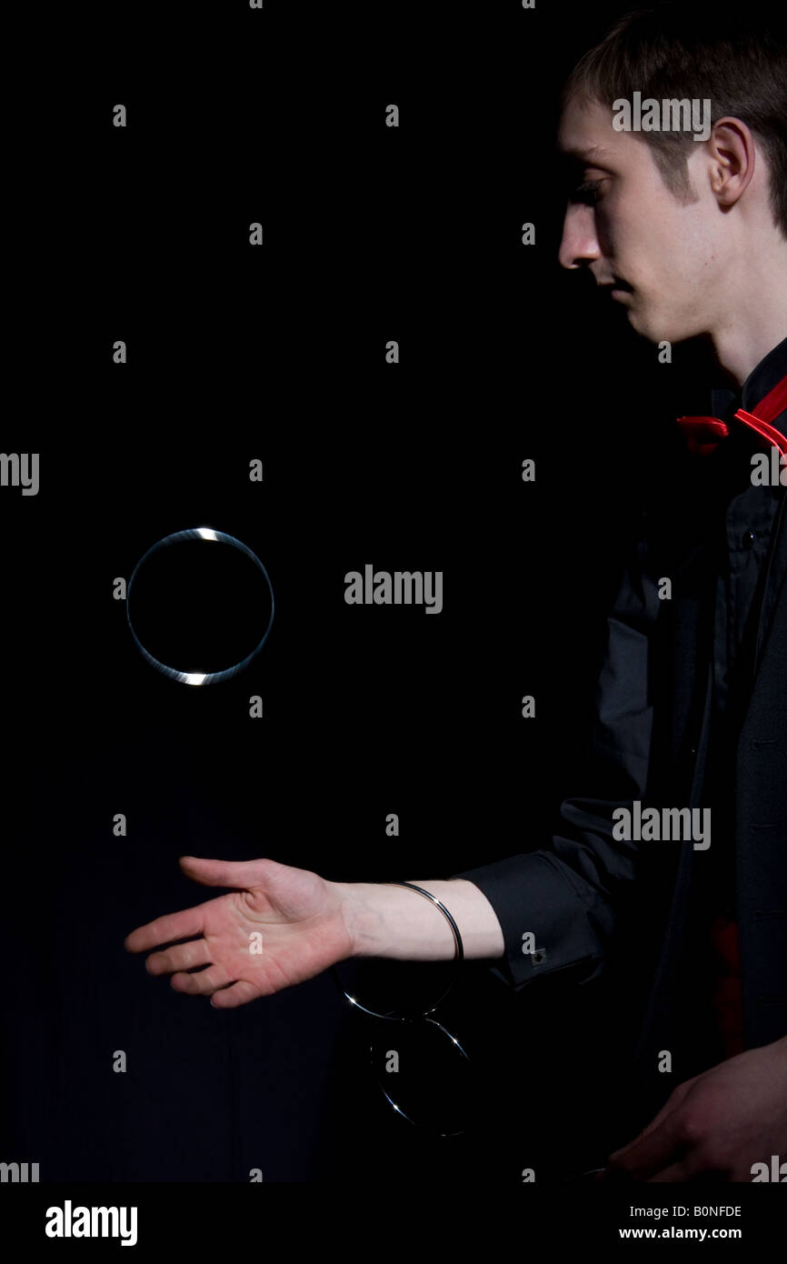 young magician performing trick with a hoop Stock Photo - Alamy