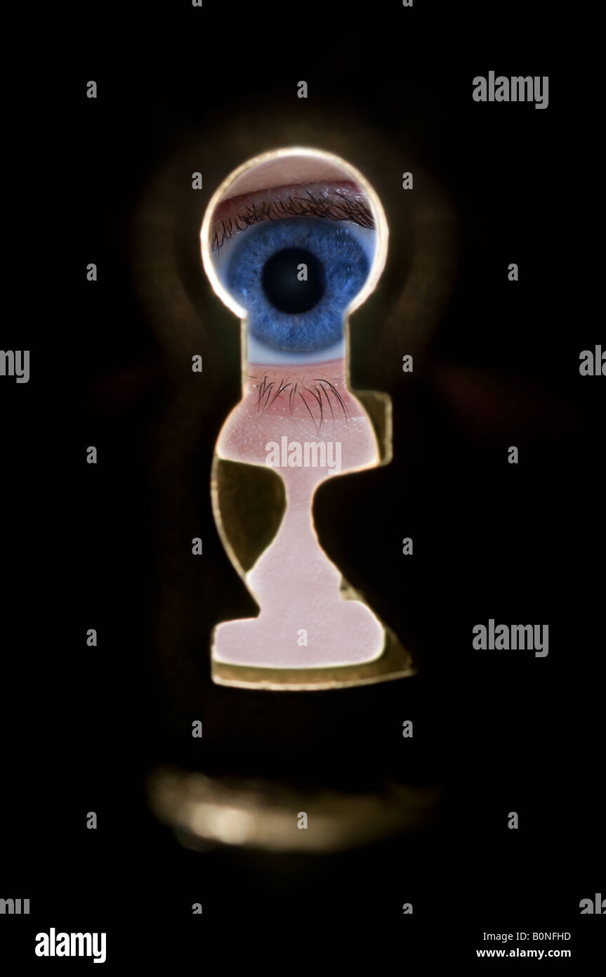A blue eye looking through an illuminated keyhole Stock Photo - Alamy