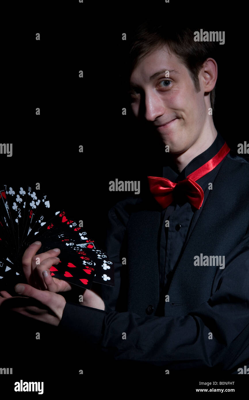young magician performing a card trick Stock Photo - Alamy
