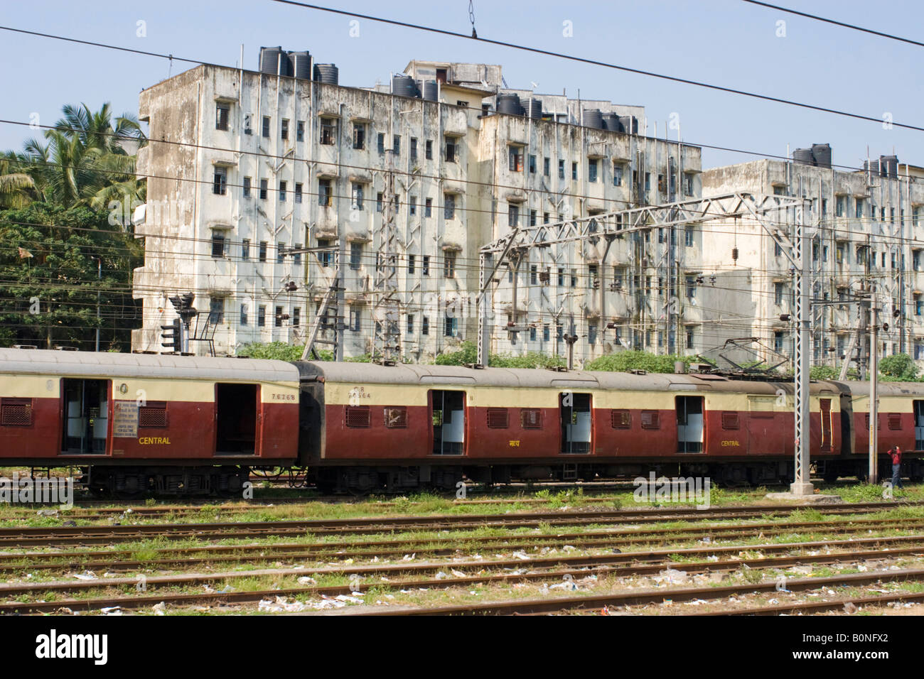 A train in a trainyard with a run down building in the background. The ...