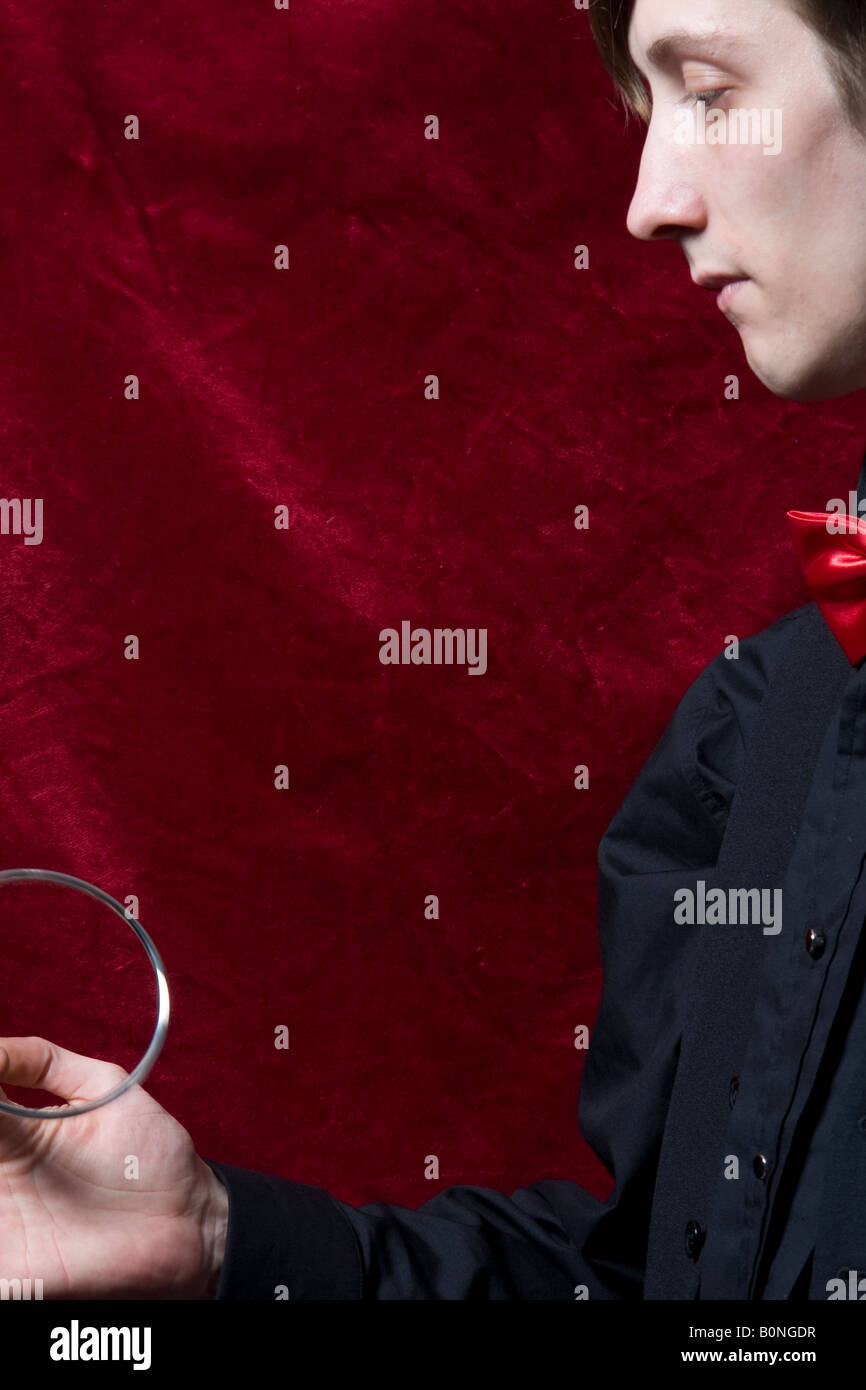 young magician performing trick with a hoop Stock Photo - Alamy