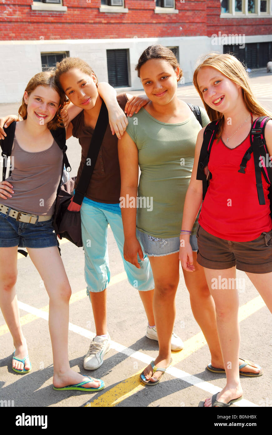 Portrait of a group of four young girls near school building Stock ...