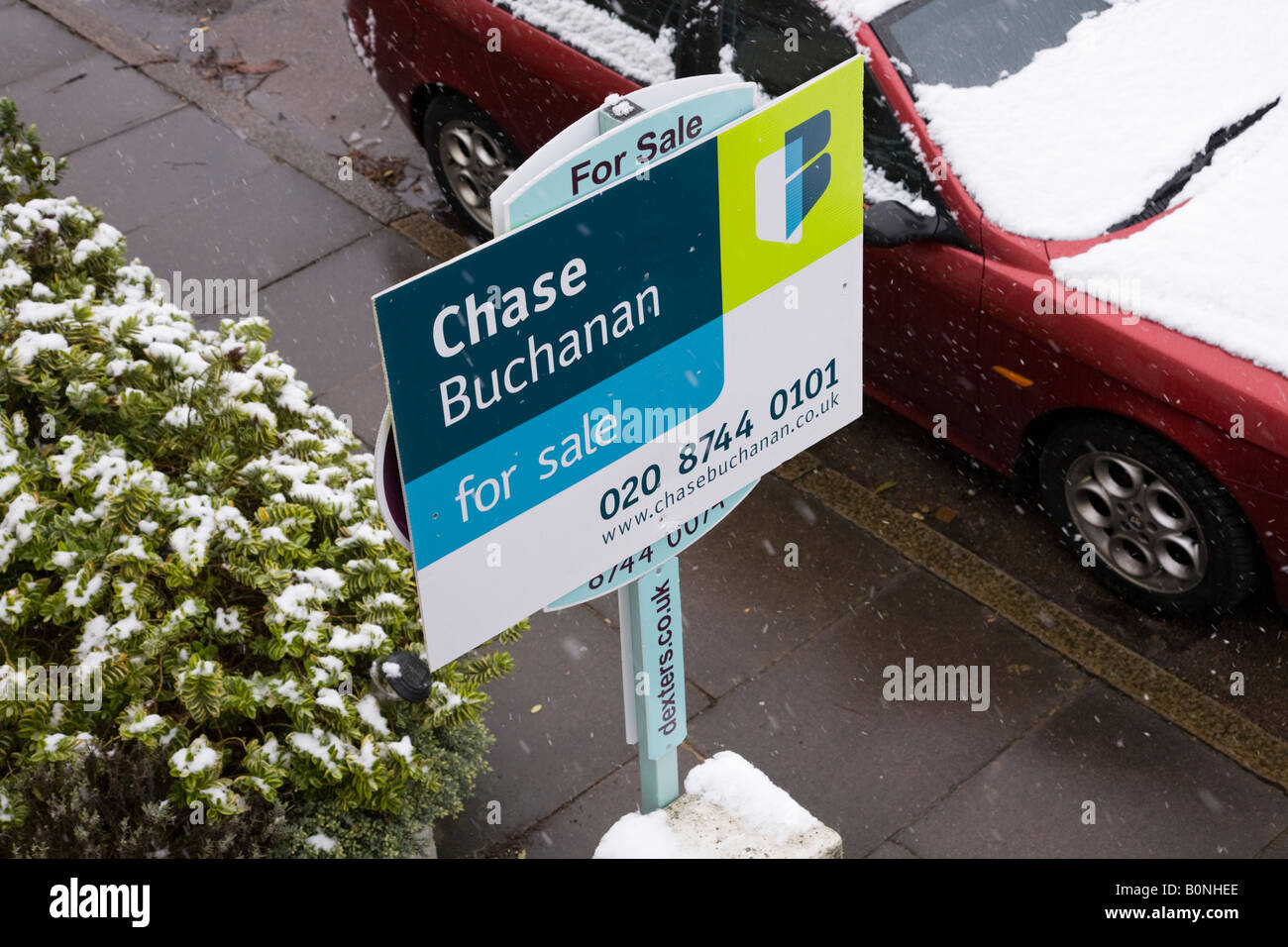 For Sale sign boards and snow, to illustrate a house sale during winter ...