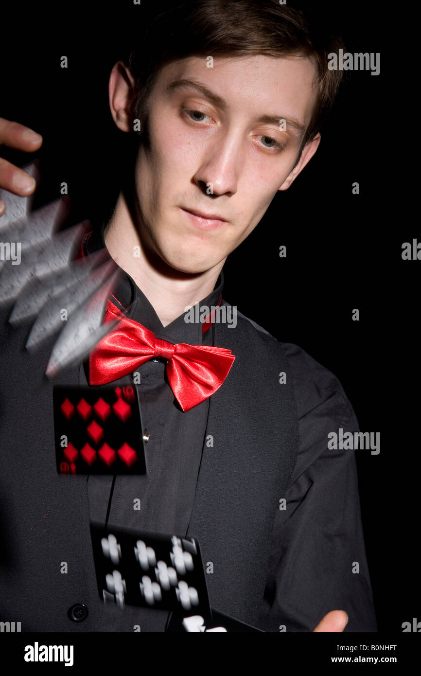 young magician doing a card trick Stock Photo - Alamy
