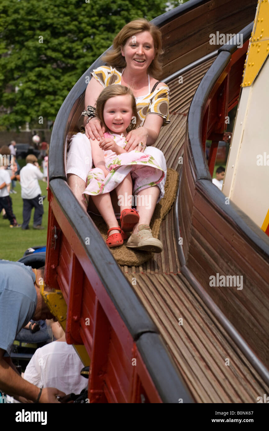 Mother and daughter on the helter skelter slide at the Richmond Upon ...