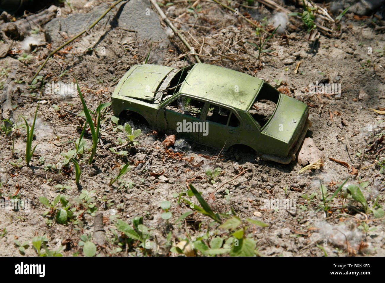 old damaged green toy car in field Stock Photo - Alamy