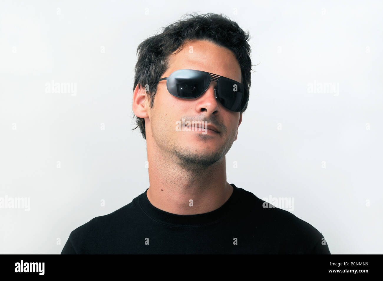Portrait of young handsome male model wearing sunglasses isolated Stock ...