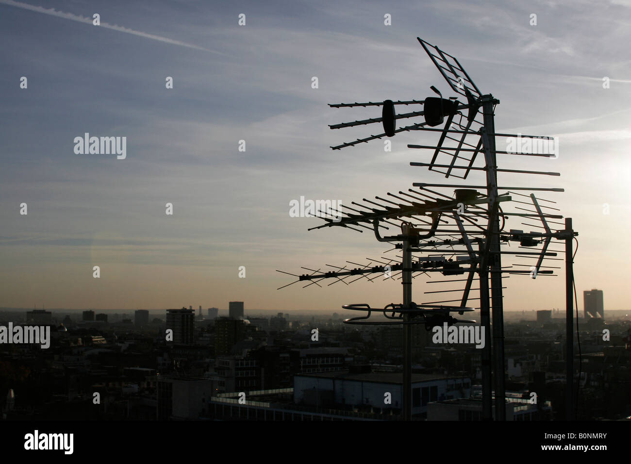 TV Aerials and radio antenna on top of a roof high over London Stock ...