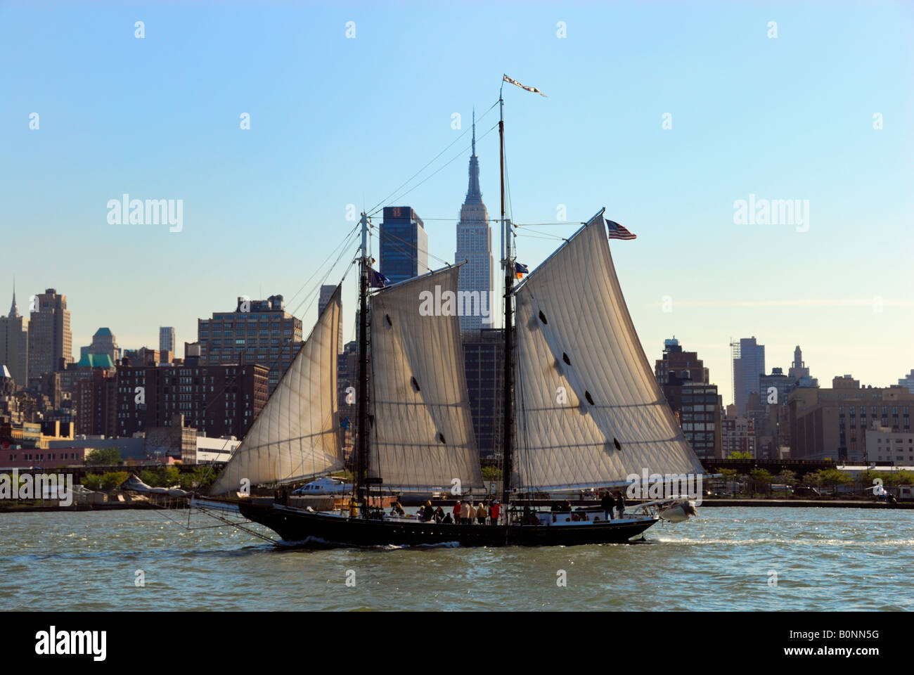 Schooner sailing up the Hudson River past Manhattan, with Empire State ...