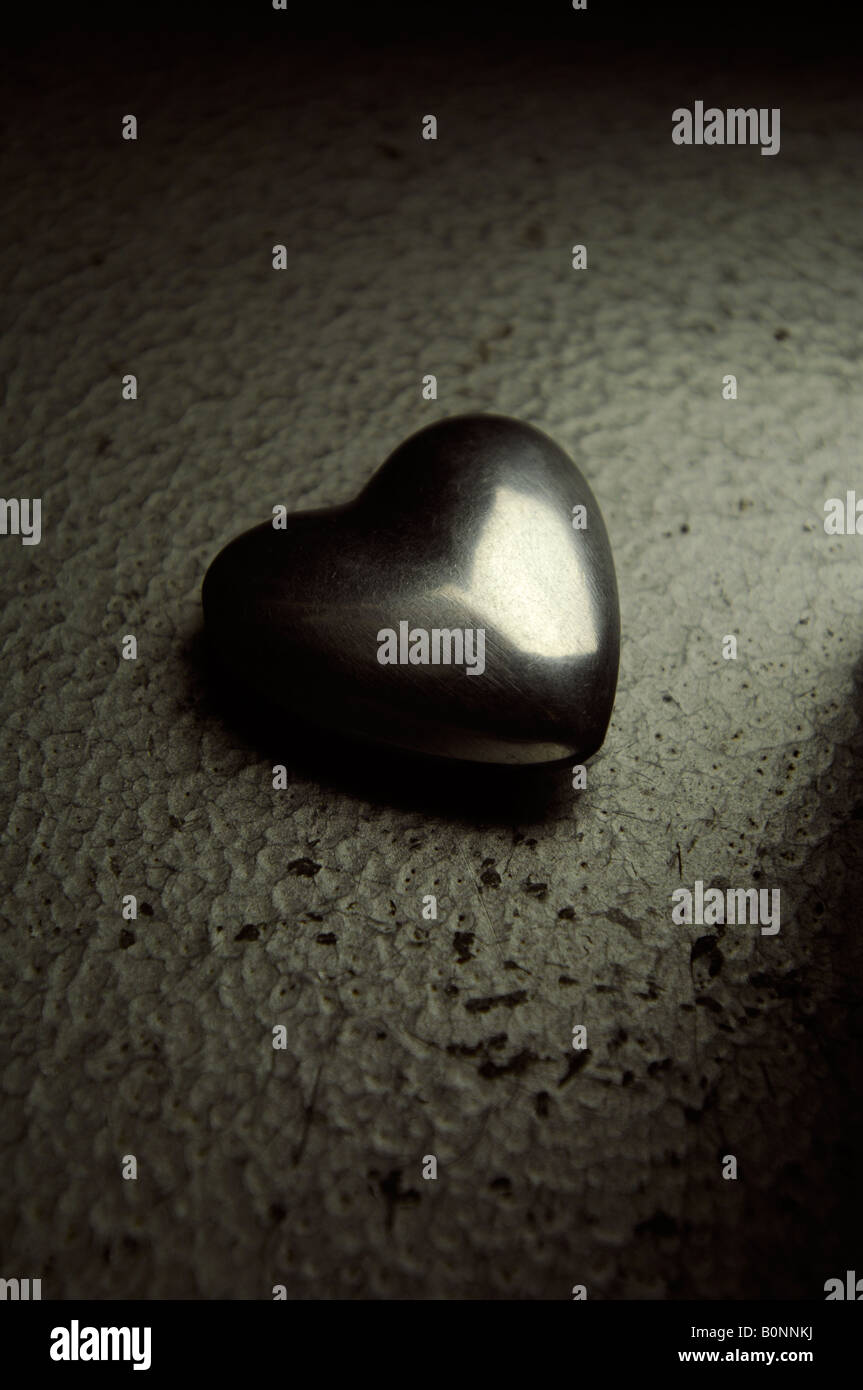small steel heart on painted metal background Stock Photo - Alamy