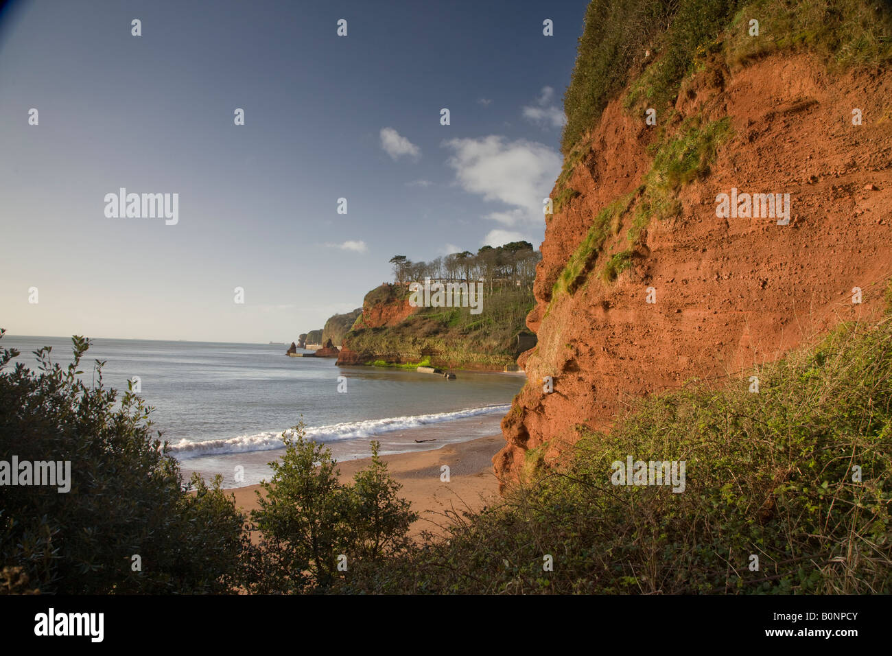Red sandstone cliffs form a dramatic background to the sea at Dawlish ...
