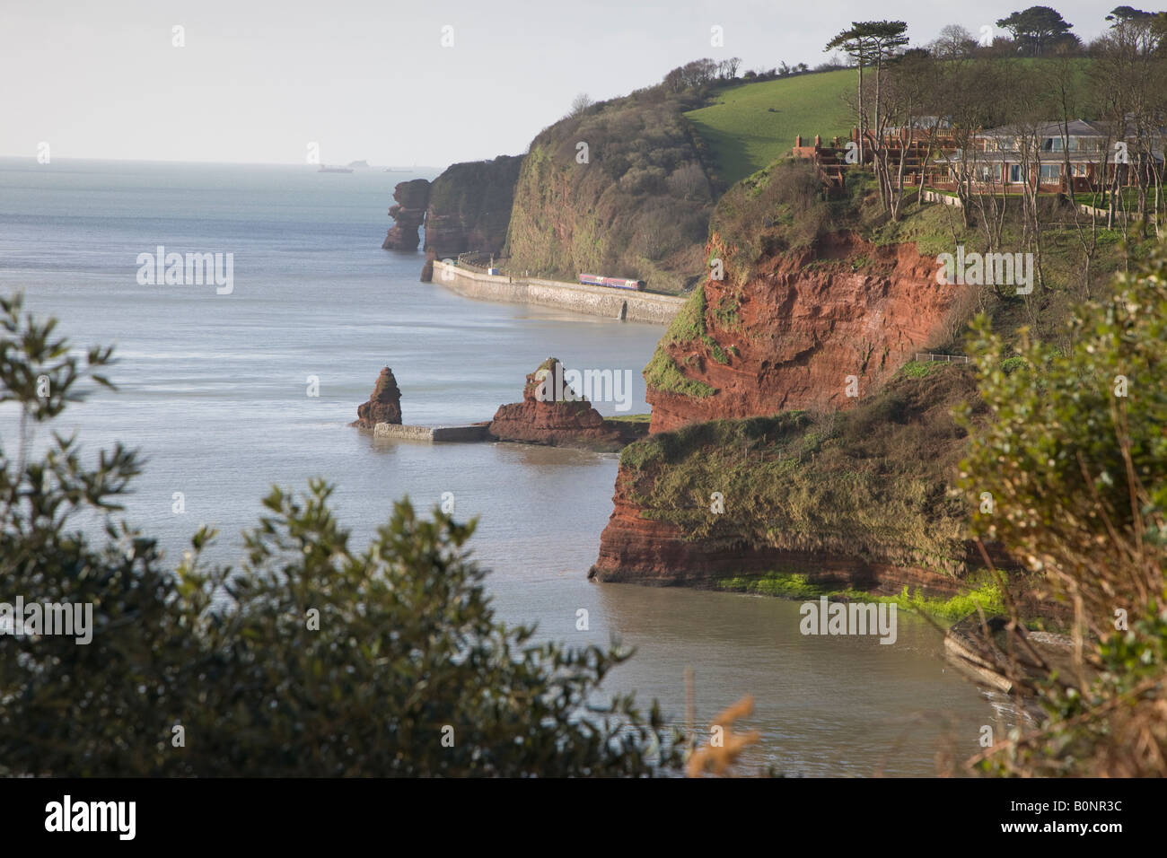 Red sandstone cliffs form a dramatic background to the sea at Dawlish ...