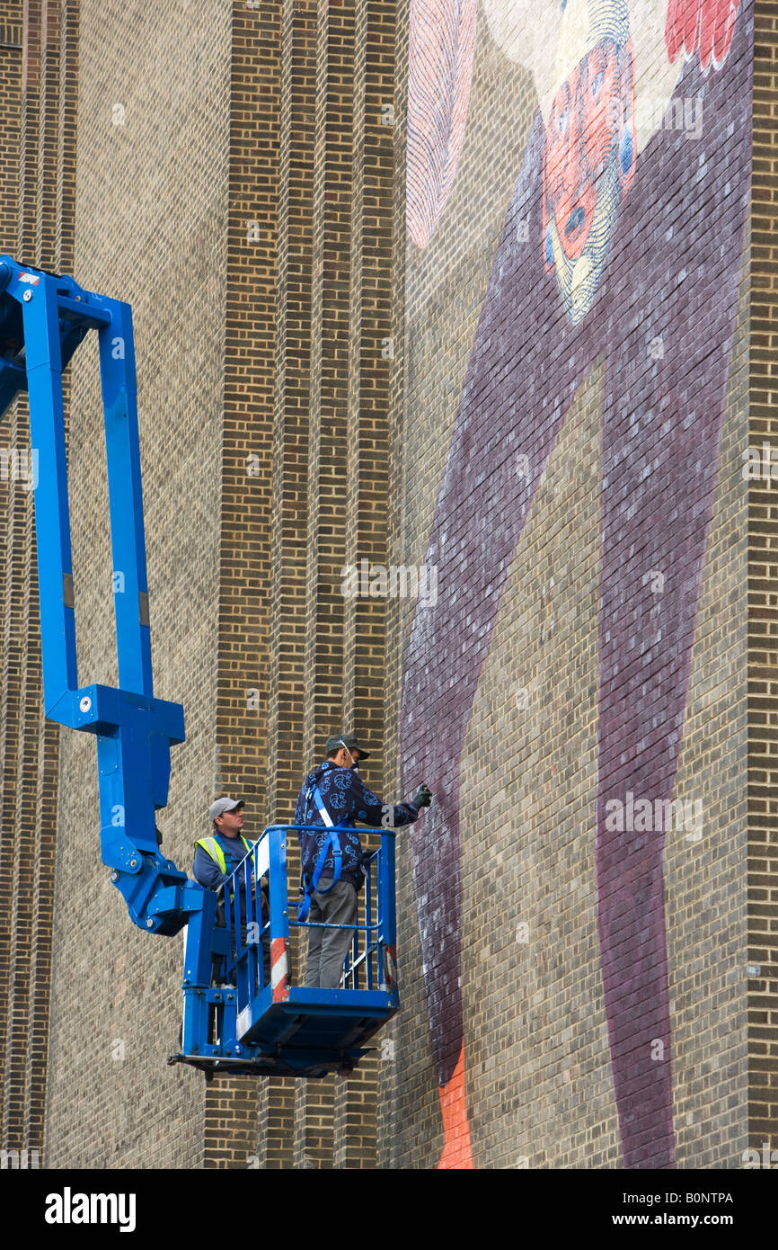 Tate Modern contemporary modern art wall mural being created by men in ...