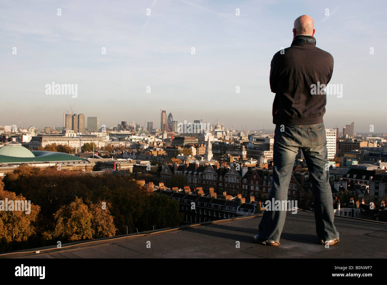 Man looking across at the view of the City of London and beyond Stock ...