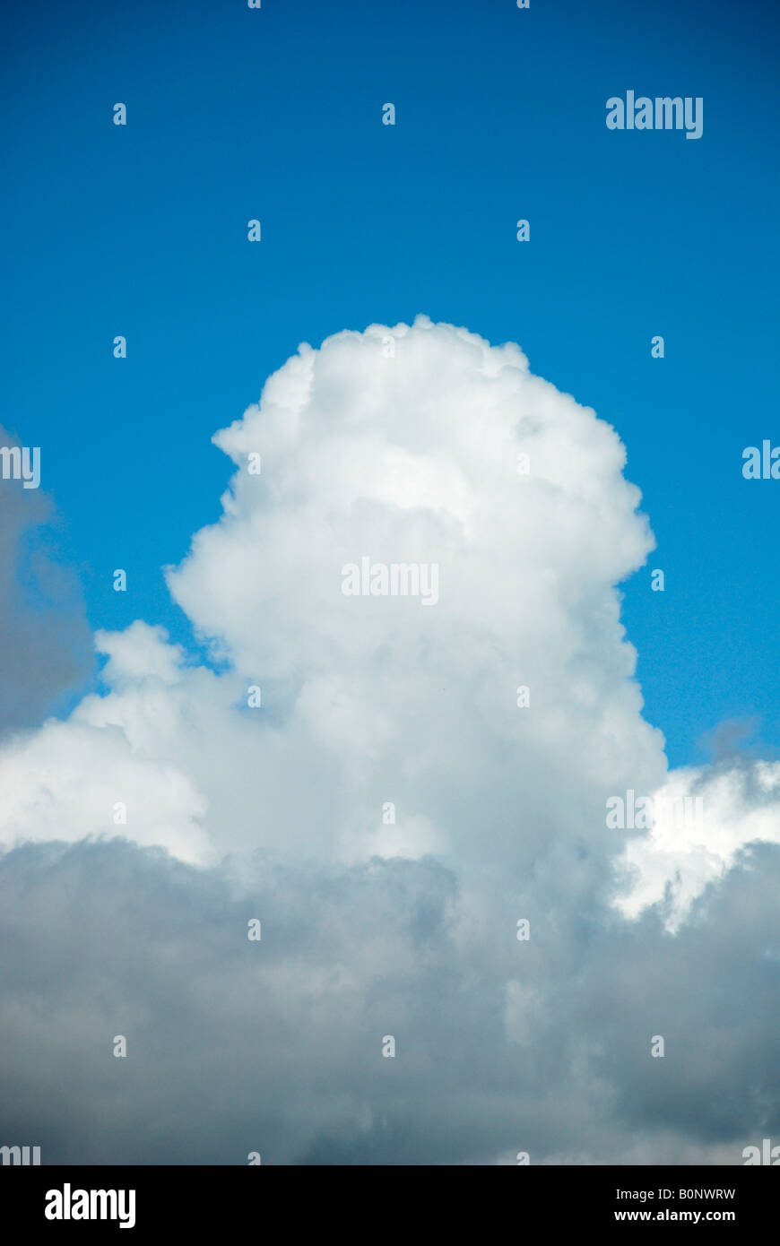 large cloud building against blue sky Stock Photo - Alamy