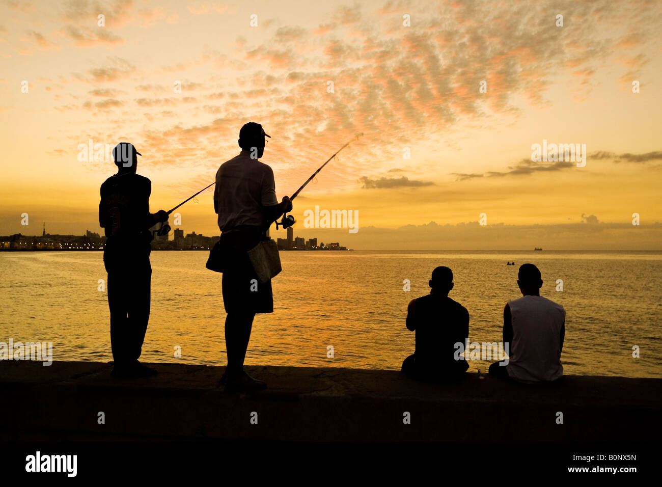 Cuban men fish at the seaside. Malecon. Havana. Cuba Stock Photo - Alamy