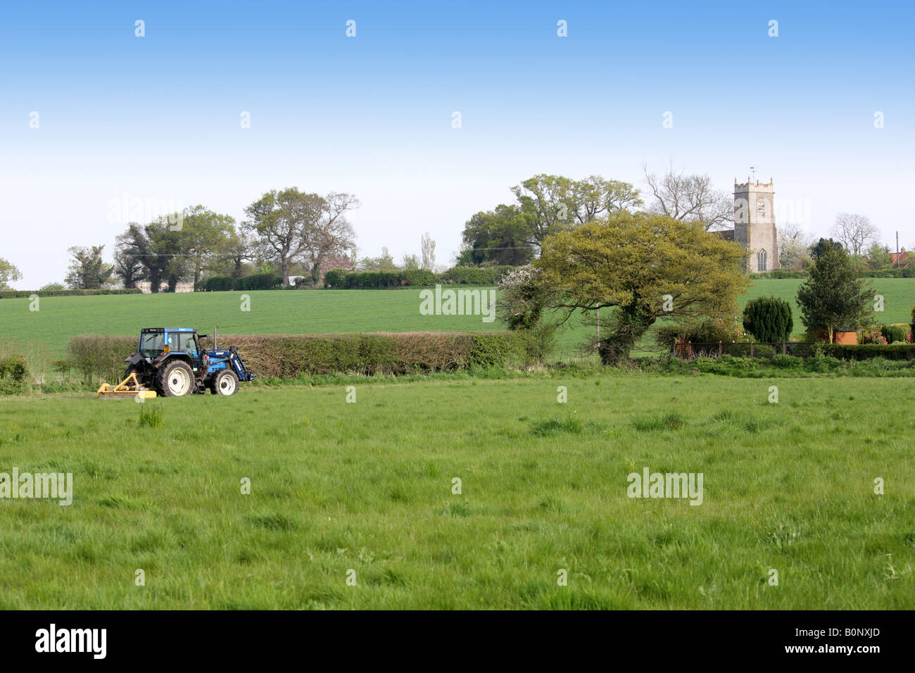 Farmer giving a pasture the first mow of the season "North Norfolk" UK ...