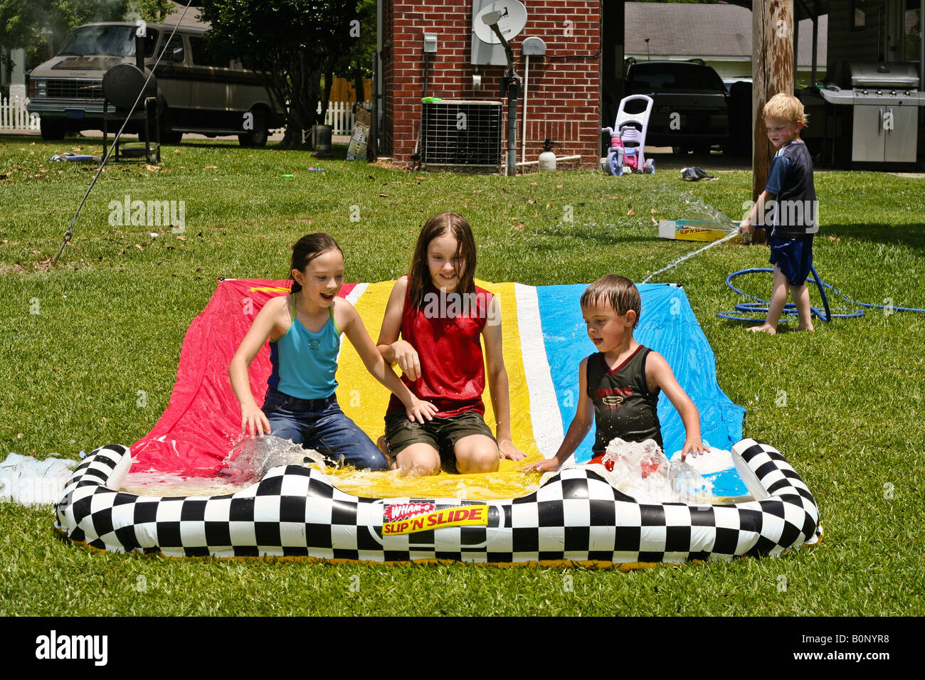 Children on water slide hi-res stock photography and images - Alamy