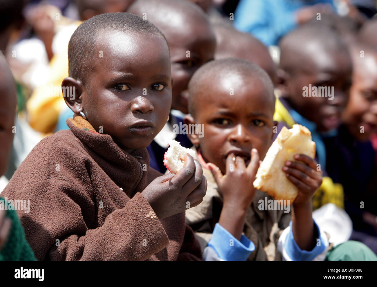 Refugee child eating hi-res stock photography and images - Alamy