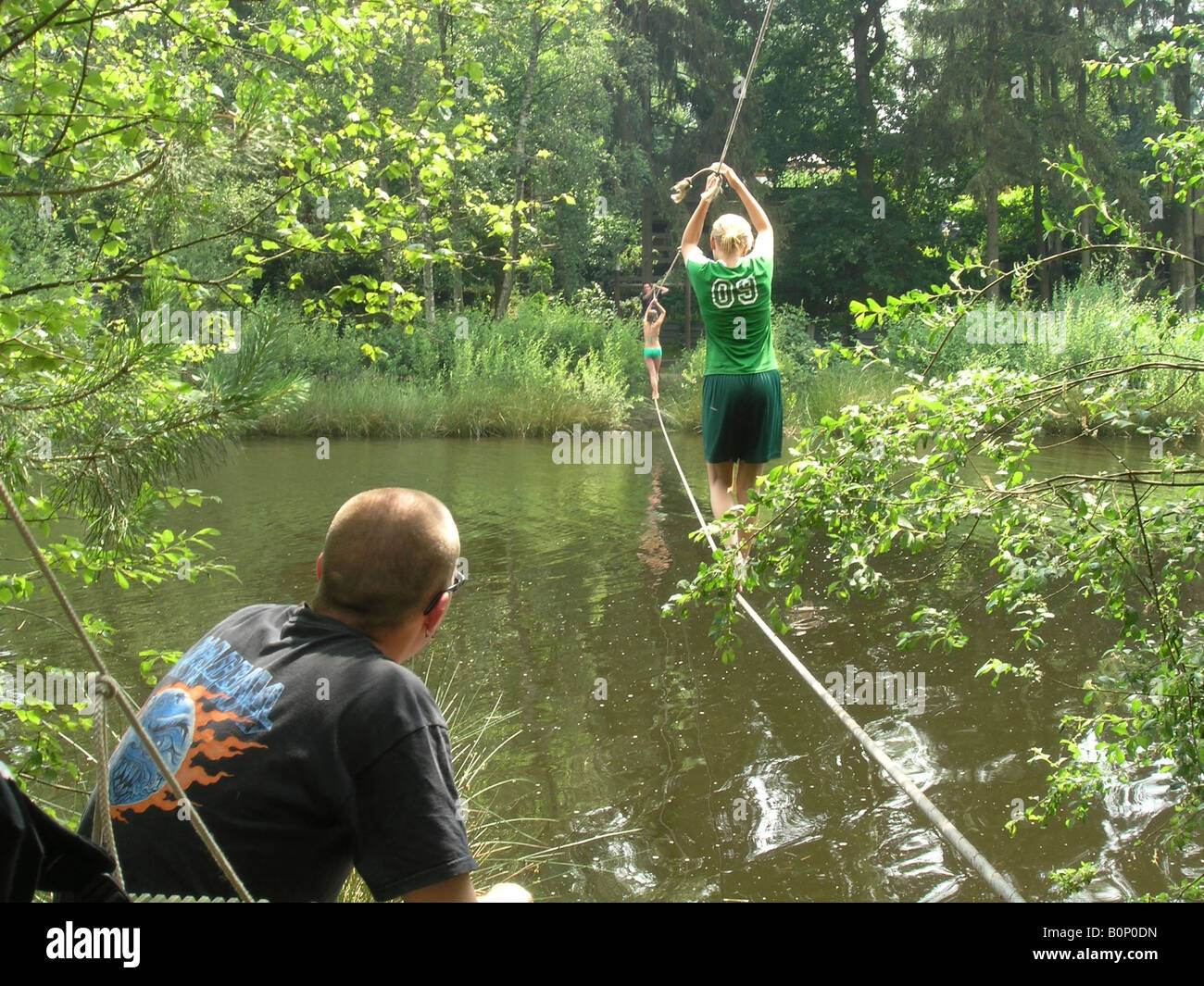 student crossing river by rope ladder Stock Photo - Alamy