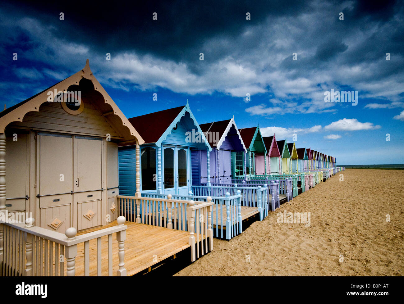 A row of colourful Beach Huts on West Mersea beach in Essex Stock Photo ...