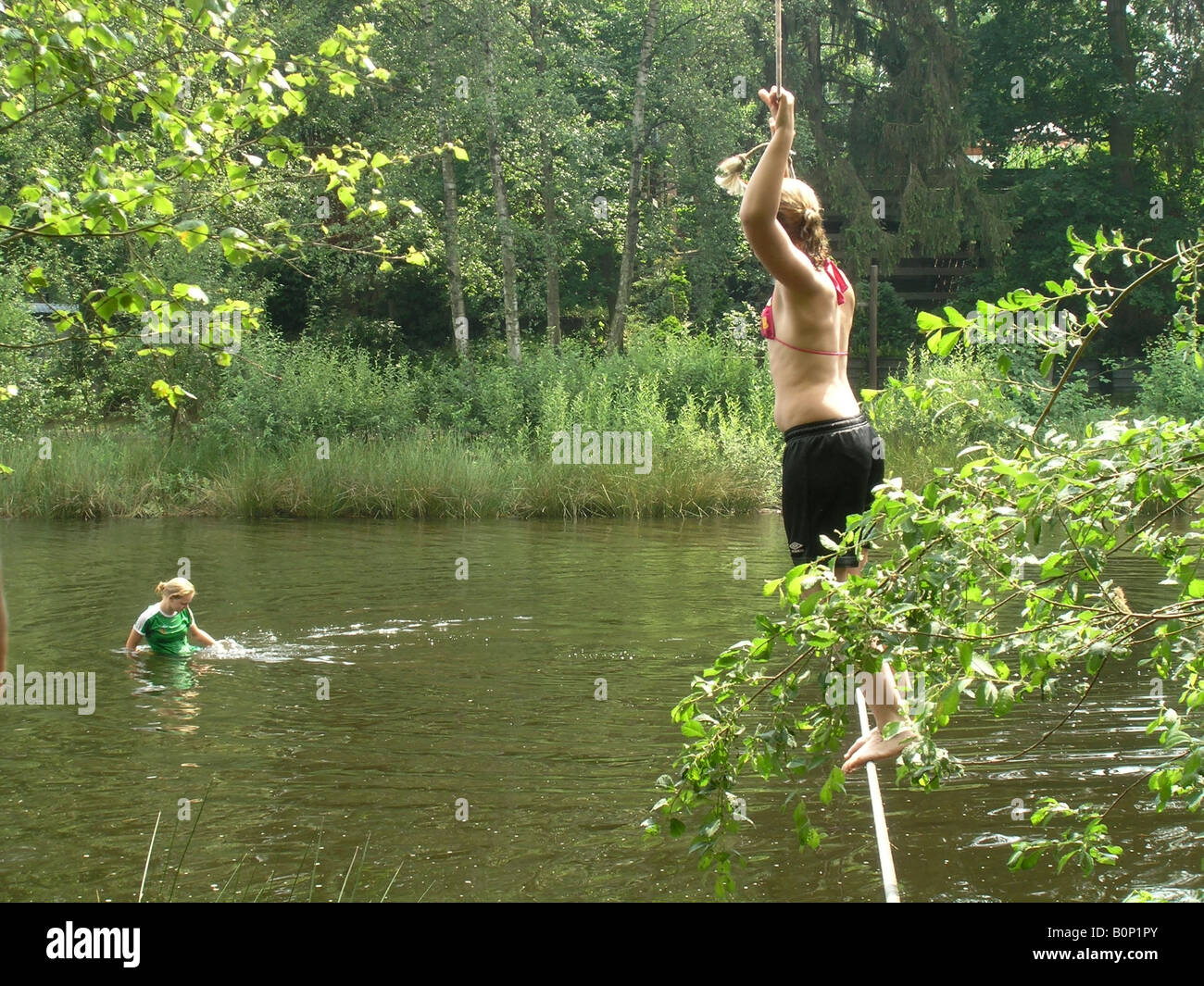 student crossing river by rope ladder Stock Photo - Alamy
