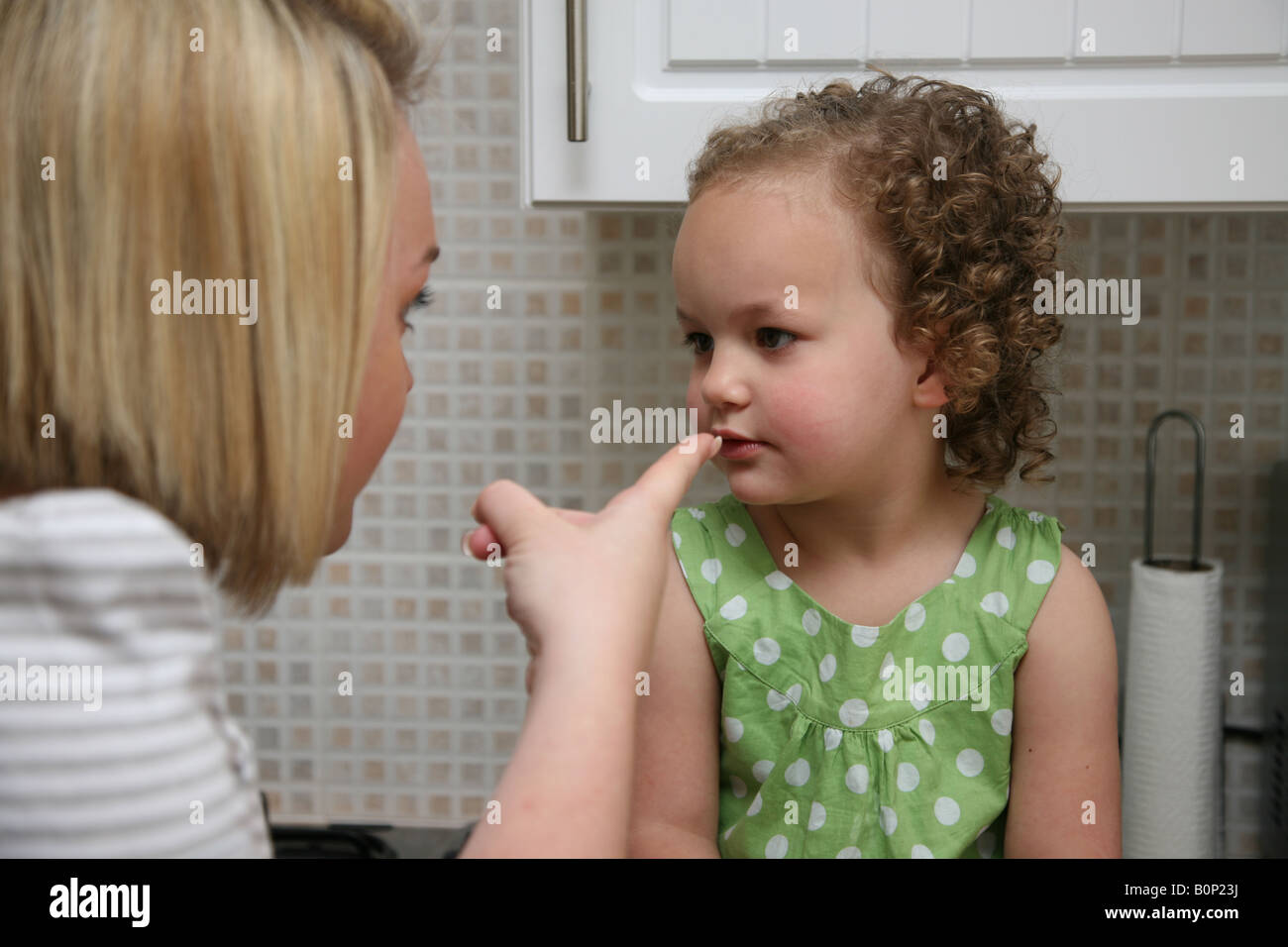 A disobedient child being told off my her mother Stock Photo - Alamy