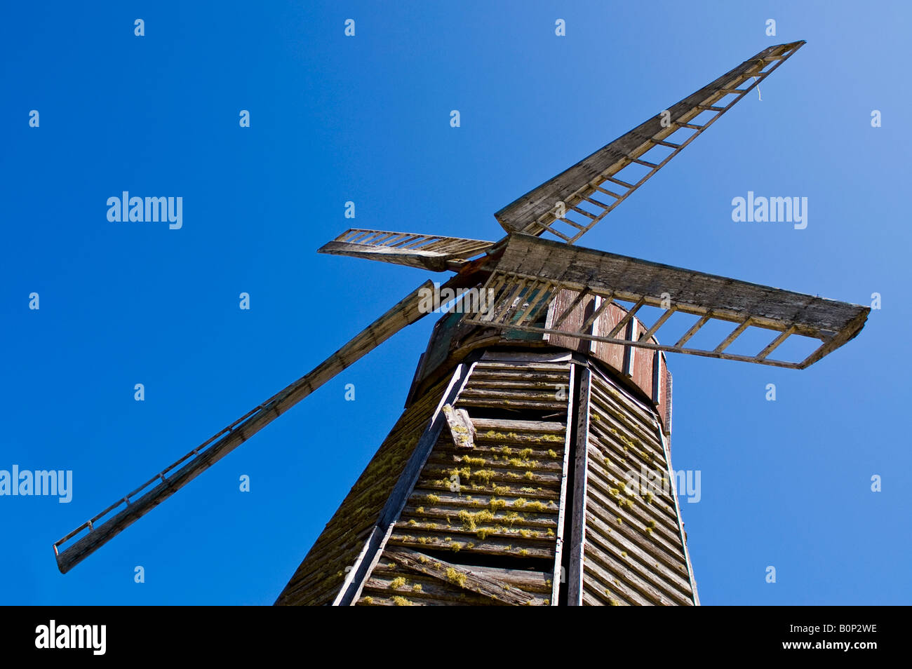 An abandoned windmill set against a blue sky Stock Photo - Alamy