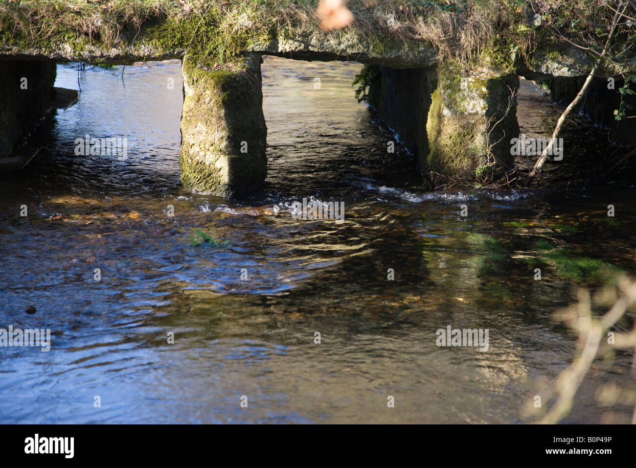 Granite bridge over stream at Widecombe Dartmoor Stock Photo - Alamy