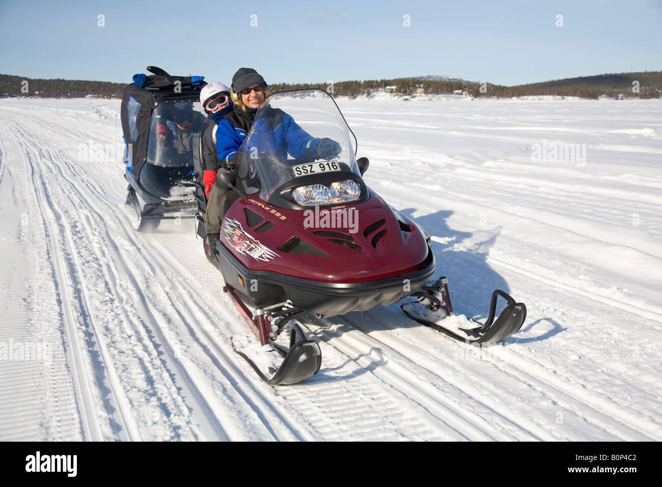 Woman sitting on snowmobile hi-res stock photography and images - Alamy