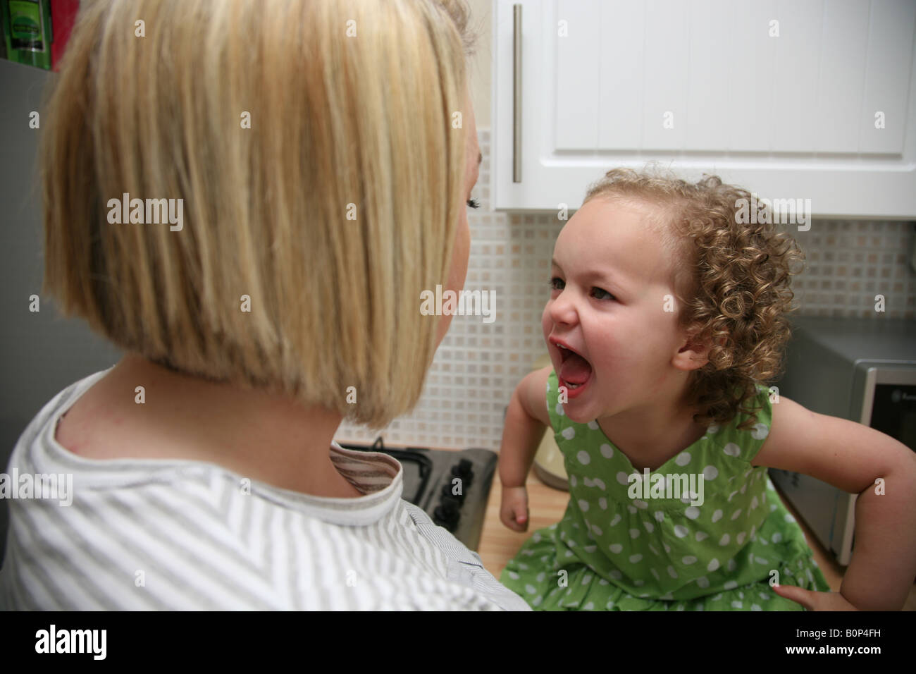 Toddler having a temper tantrum and screaming at her mother Stock Photo ...