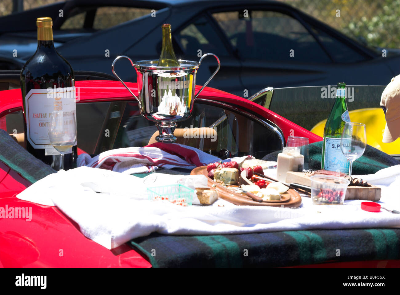 Wine, cheese and crackers set up on the back of a Ferrari at Concorso ...