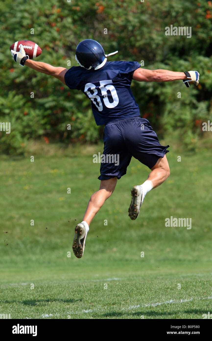 American football player jumping up to make a great catch Stock Photo ...