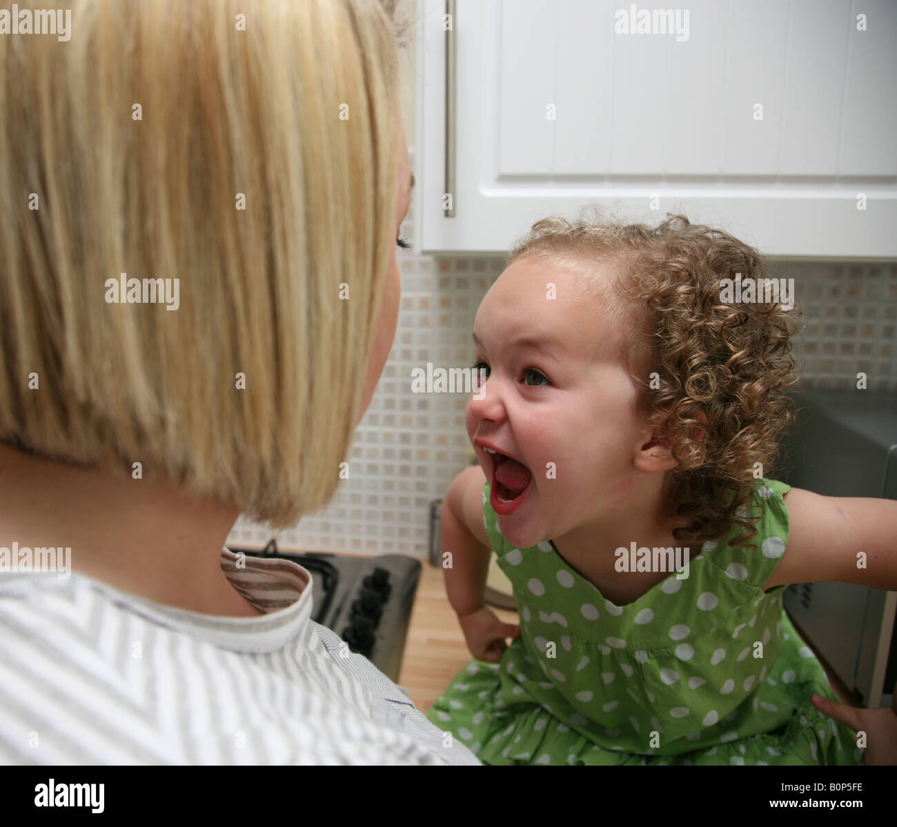 Toddler having a temper tantrum and screaming at her mother Stock Photo ...